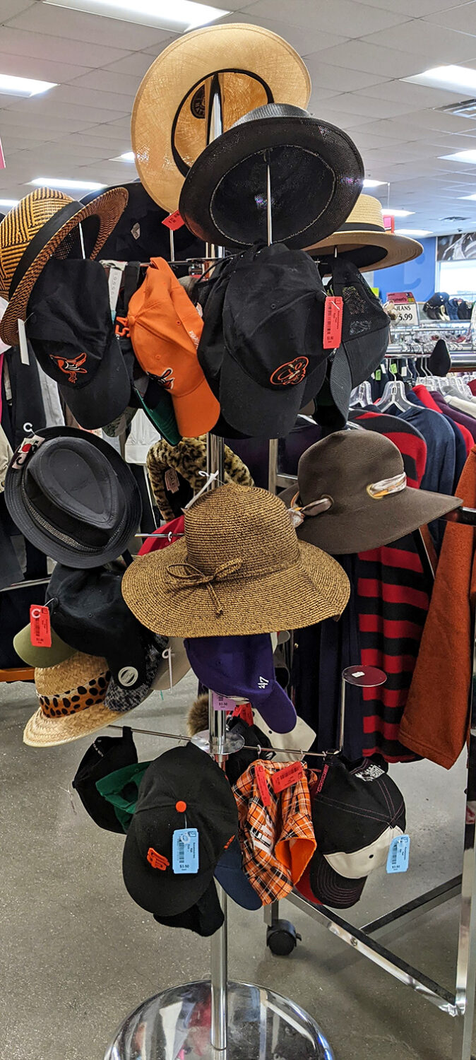 The hat rack: where Baltimore Orioles caps mingle with church lady sun hats in a fashion democracy that department stores can only dream about.