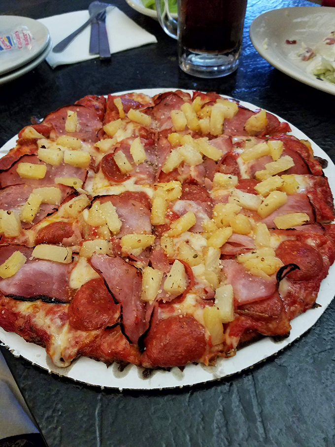 Hawaiian Pizza – where sweet pineapple chunks and savory ham create that controversial yet irresistible combination that's divided families but united taste buds since the 1960s.