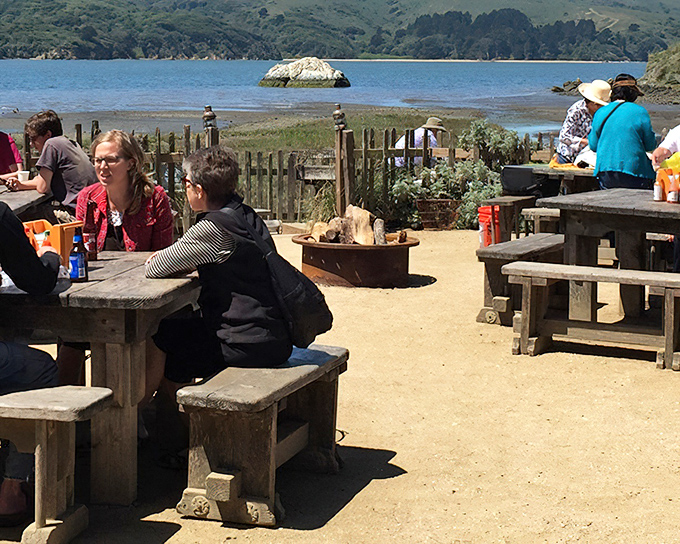 Outdoor dining with a view that makes even mediocre food taste magnificent—though thankfully, mediocre is never on the menu at these bayside tables.