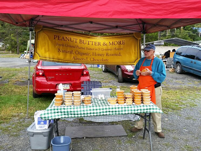 The peanut butter philosopher. Fresh-ground, honey-roasted, and chocolate varieties await beneath a banner that promises simple, spreadable joy.