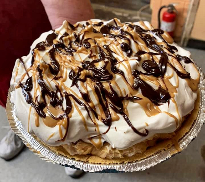 Not just pie—a towering monument to the sweet arts, with chocolate and caramel drizzles performing an edible Jackson Pollock across the top.