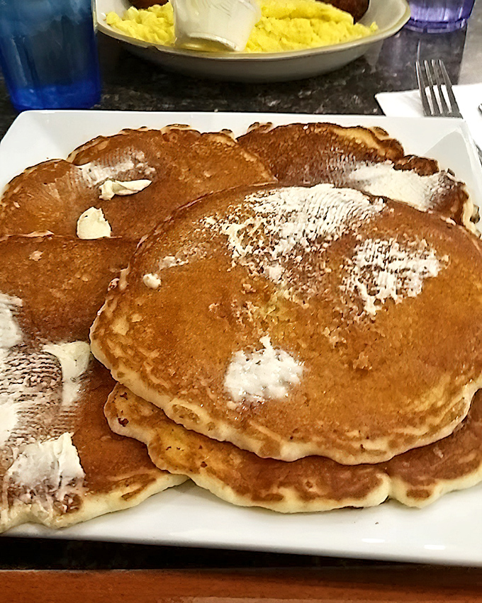 Pancakes so golden and fluffy they deserve their own Instagram account. The butter melts into little pools of happiness that make Monday mornings bearable.