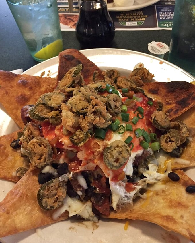 These loaded nachos aren't just a meal, they're an architectural achievement &ndash; layers of flavor stacked higher than your weekend to-do list.