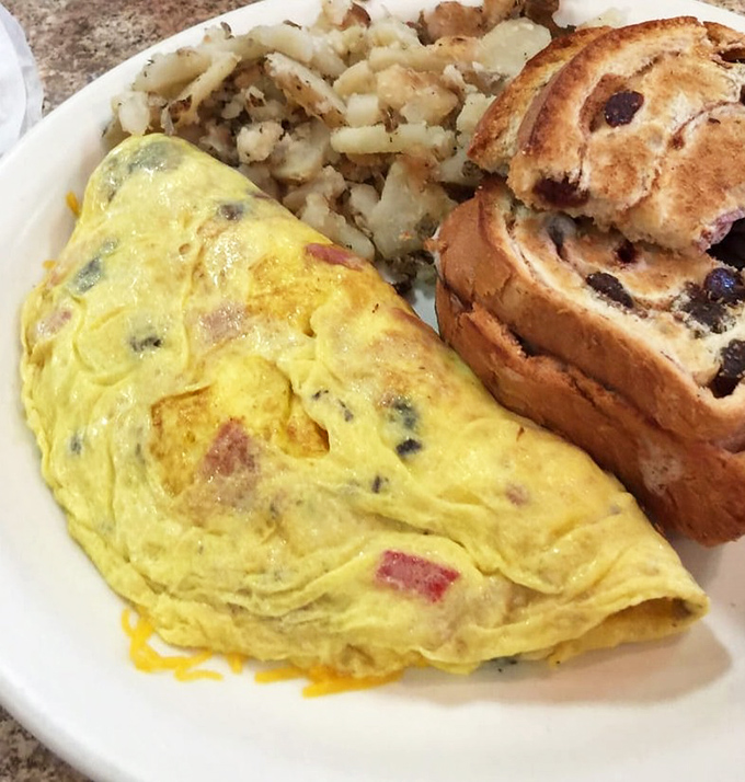 An omelet that's achieved the impossible dream: perfectly cooked eggs cradling a treasure trove of fillings. That cinnamon raisin toast deserves its own spotlight.