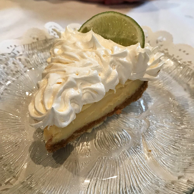 Key lime pie with a cloud of whipped cream—the dessert equivalent of a perfect beach day, minus the sunburn.