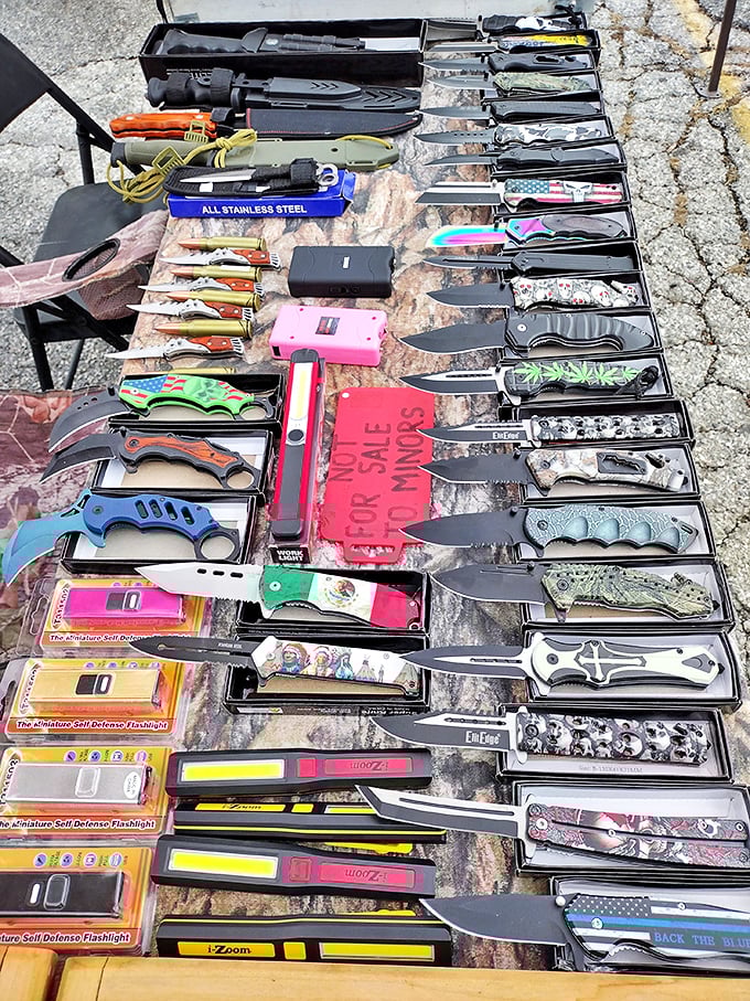 The knife seller's display—where practical tools meet questionable fashion statements. Every dad within fifty miles feels an inexplicable pull toward this table.