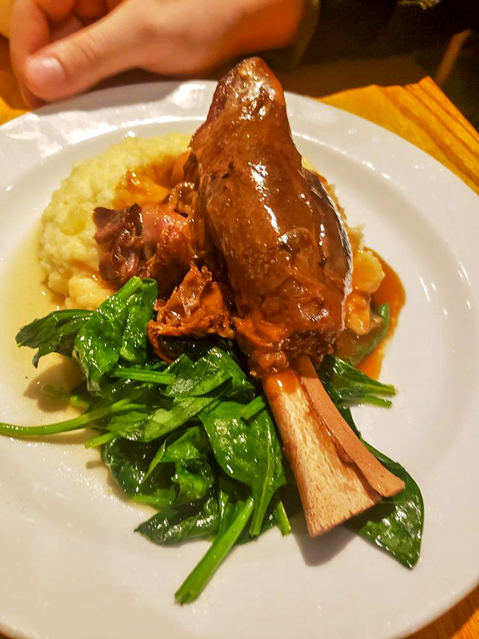 The legendary lamb shank in its natural habitat&mdash;falling off the bone and surrounded by greens that somehow avoid being mere spectators.