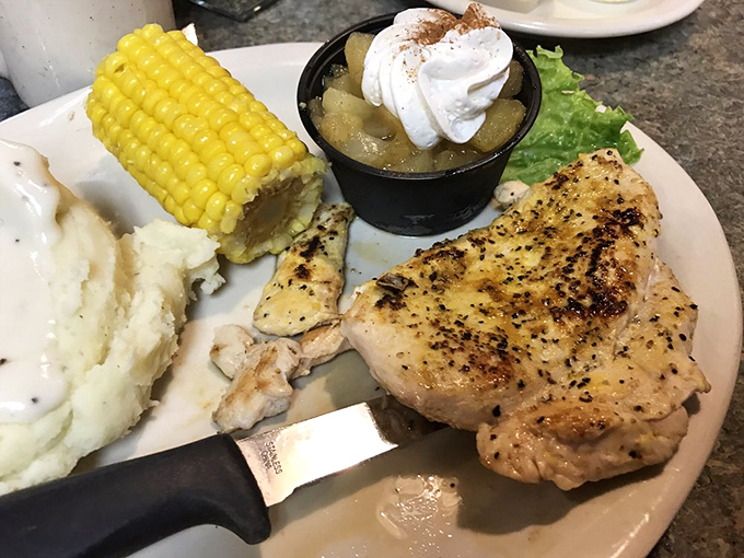 A perfectly seasoned chicken breast keeps company with corn on the cob and a side of cinnamon-topped apples. Comfort food gets a touch of elegance.