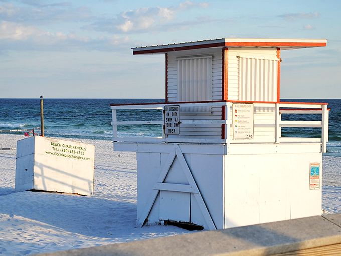 The lifeguard station stands sentinel over paradise, like a tiny beach house that forgot to pack its foundation.