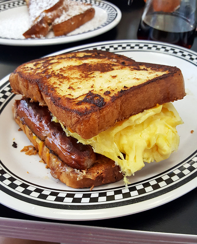 This breakfast sandwich towers like a delicious skyscraper, engineered for maximum morning satisfaction and pure joy.