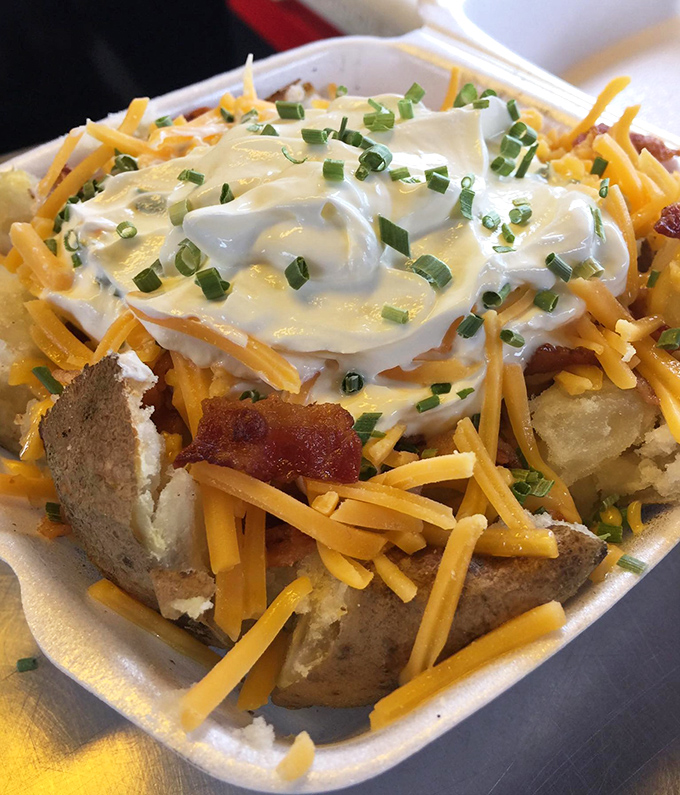 The loaded potato isn't just loaded&mdash;it's having an existential crisis under all those toppings. Cheese, scallions, and sour cream create a beautiful chaos.