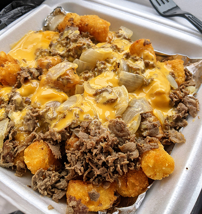 Tater tots elevated to an art form—smothered in cheese, meat, and onions. Comfort food that hugs your soul while plotting against your arteries.