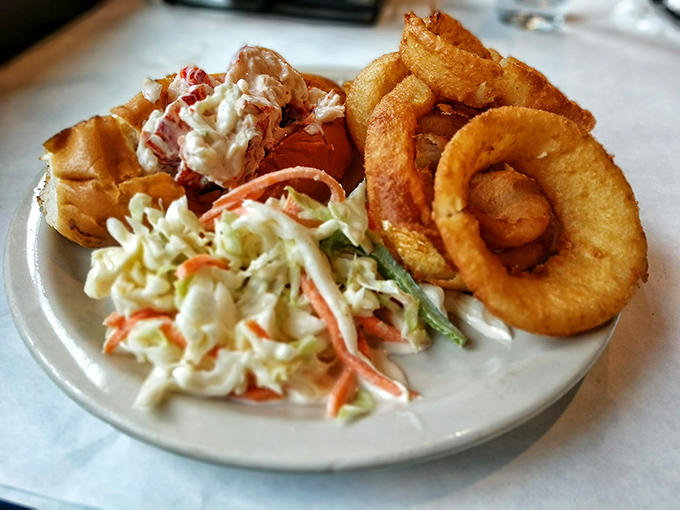 A classic New England lobster roll meets coleslaw and onion rings. This plate is like summer vacation for your taste buds.