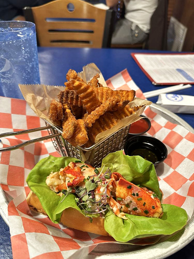 The lobster roll's entourage includes waffle fries and what appears to be seafood's best friend&mdash;more seafood. Talk about squad goals.