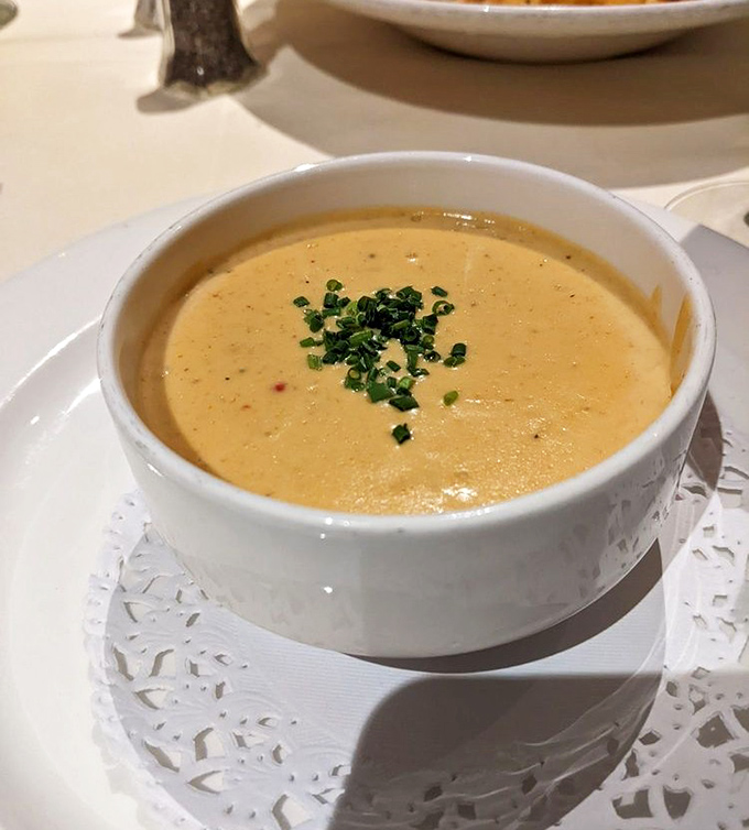 This lobster bisque isn't just soup; it's liquid luxury with a sprinkle of chives that whispers, "You deserve this moment."