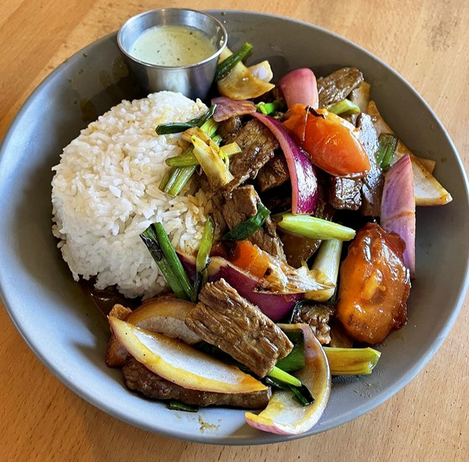 A bowl of Lomo Saltado that balances hearty and fresh&mdash;tender beef, crisp vegetables, and rice that's ready to soak up every last drop of sauce.