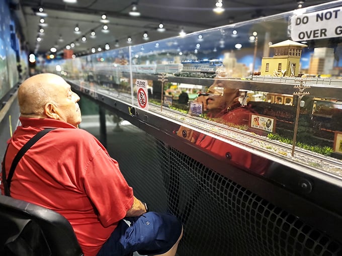 The magic of miniature worlds knows no age limit. This visitor finds the same joy in tiny trains that captivated him decades ago.