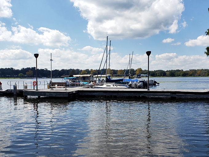 A marina where boats wait patiently for their next adventure. The still water mirrors the sky, doubling the day's beauty for free.