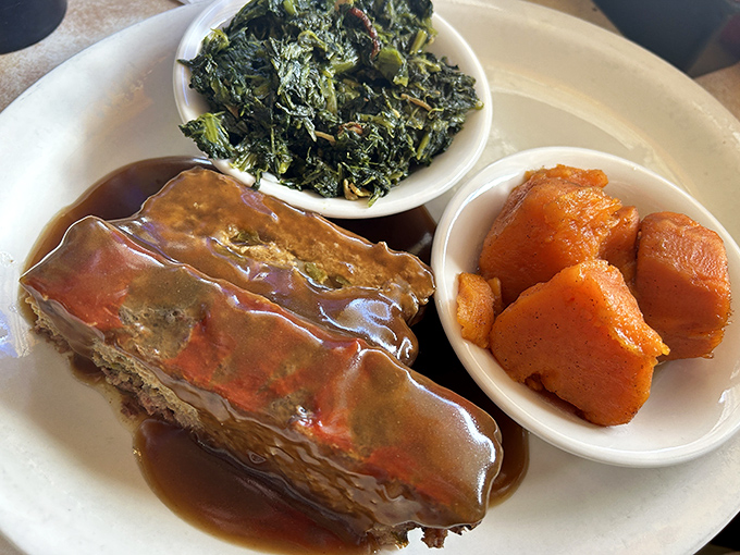 Meatloaf swimming in gravy with sides of greens and sweet potatoes&mdash;a plate that whispers "your grandmother would approve."