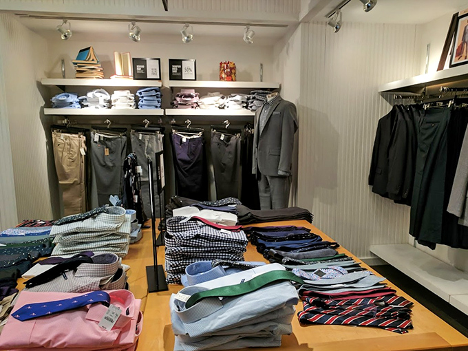 Men's dress shirts stacked with military precision. The hardest decision isn't whether to buy, but which colors to take home.