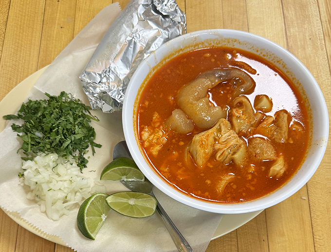 A bowl of menudo that could cure everything from hangovers to existential crises, served with all the traditional fixings.