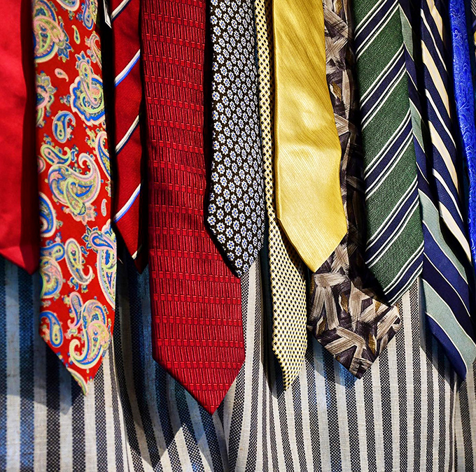 A rainbow of neckties awaits new adventures, ready to transform business casual from boring to brilliant.