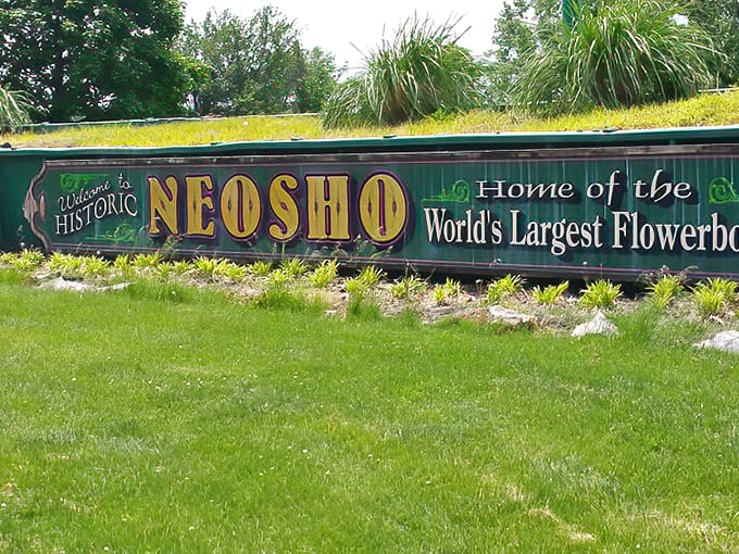 "Home of the World's Largest Flowerbox" proclaims this colorful welcome sign&mdash;proof that Neosho embraces both natural beauty and a touch of quirky small-town pride.