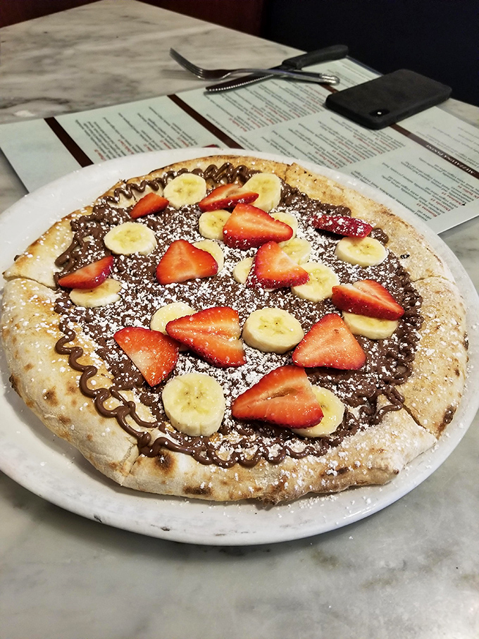 Nutella pizza: where breakfast meets dessert in a beautiful romance. The strawberries and bananas are just there to make you feel virtuous.