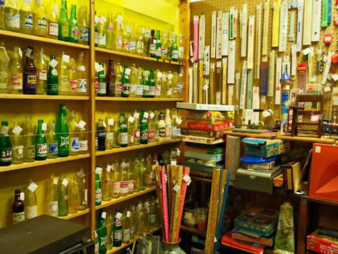 A collector's rainbow of vintage bottles lines these shelves, each one containing not liquid but stories of bygone brands and beverages.