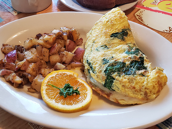 This spinach omelet practically glows with freshness, while those home fries look like they've achieved the perfect crisp-to-tender ratio.