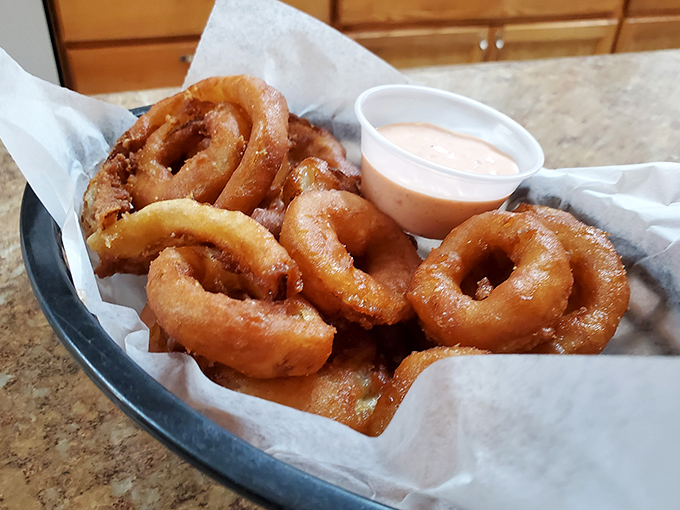 These onion rings aren't just fried&mdash;they're transformed. Crispy, golden halos of happiness served with a dipping sauce that makes you wonder why vegetables ever bothered being healthy.