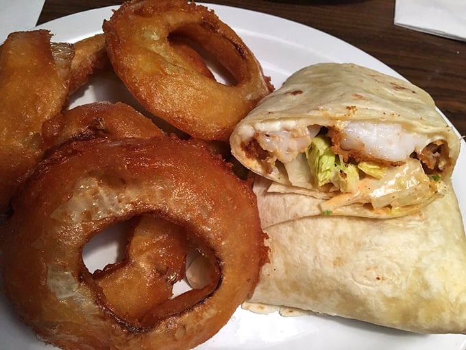 A wrap that means business alongside onion rings that achieve the perfect crunch-to-sweetness ratio&mdash;proof that simple food done right is culinary poetry. 