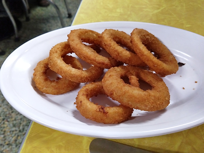 The onion ring test: perfect golden circles with that satisfying crunch that announces to the world, "This place knows what it's doing."