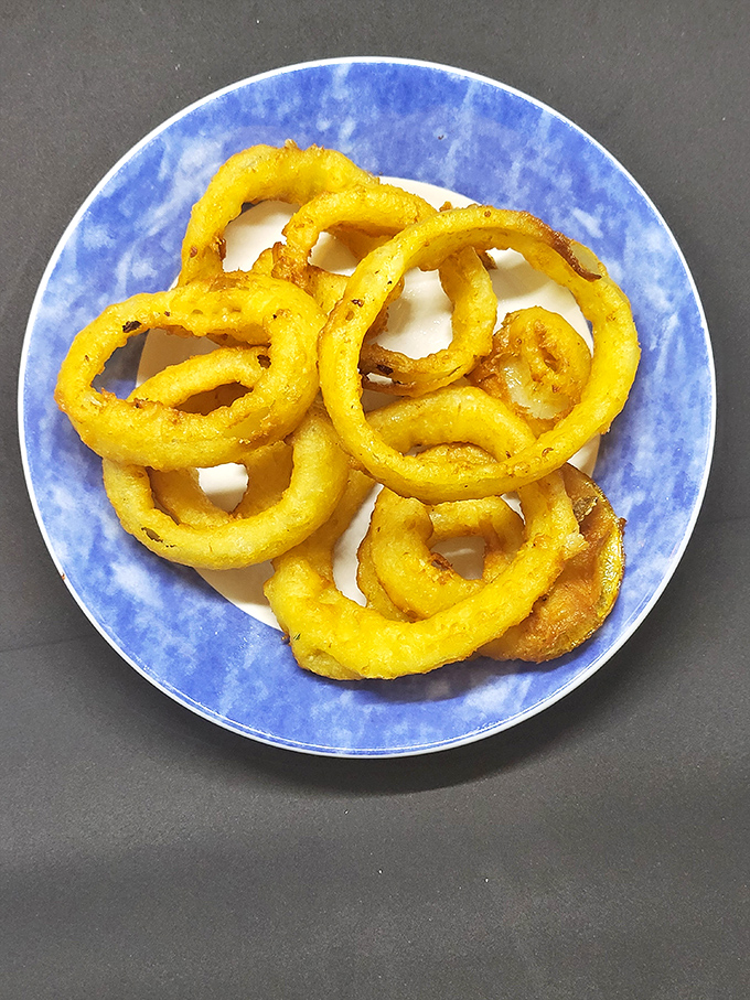 Onion rings that achieve that perfect balance between crisp exterior and sweet, tender interior—like finding the ideal dance partner who both leads and follows.