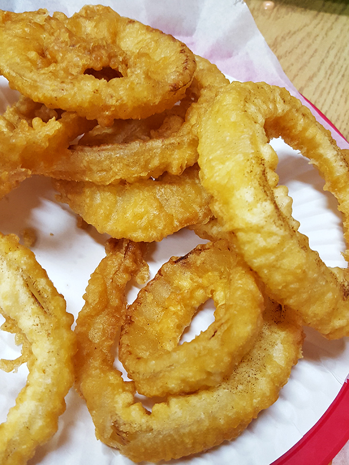 Onion rings that could double as edible jewelry. Each golden hoop offers that perfect crunch-to-squish ratio that onion ring aficionados dream about.