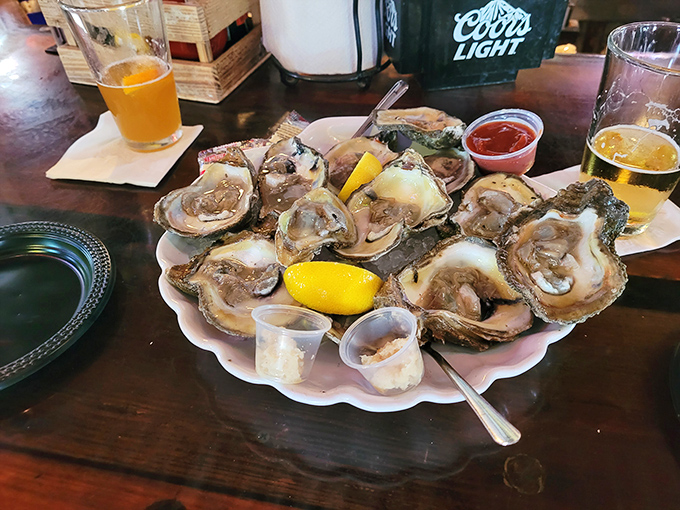 Oysters arranged like a pearl necklace, glistening with briny promise. The lemon wedges aren't garnish&mdash;they're essential supporting actors.