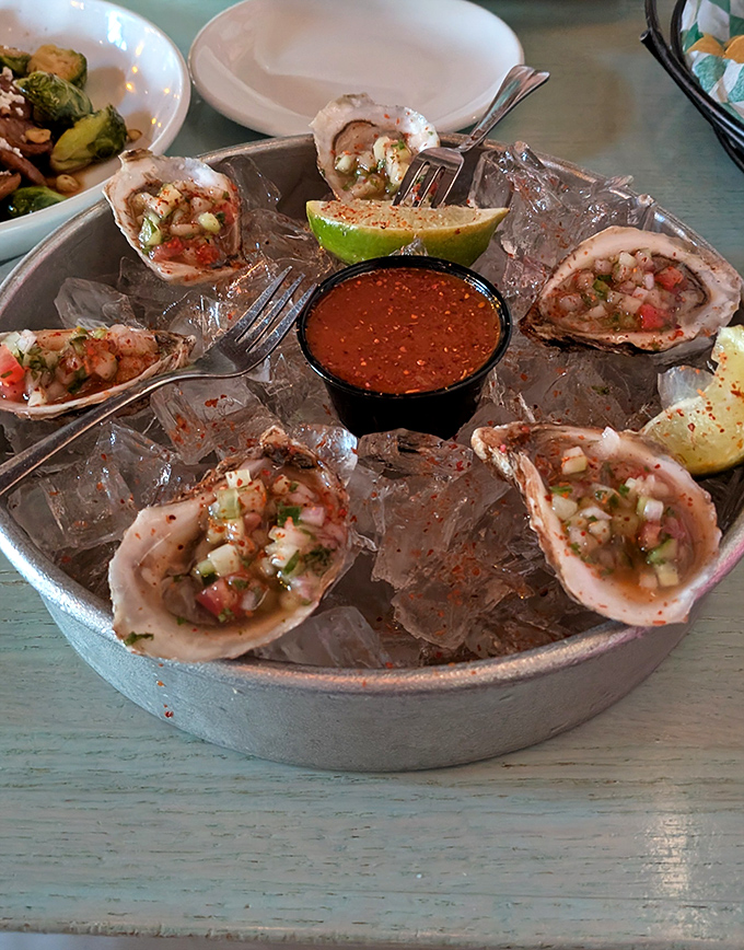 Fresh oysters on ice with zesty salsa&mdash;the ocean's perfect gift, elevated by a squeeze of lime and a dash of culinary magic.