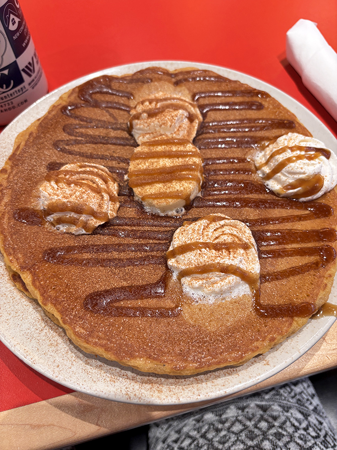 A pancake so perfectly golden it could win medals, topped with butter medallions that melt into sweet maple rivers.