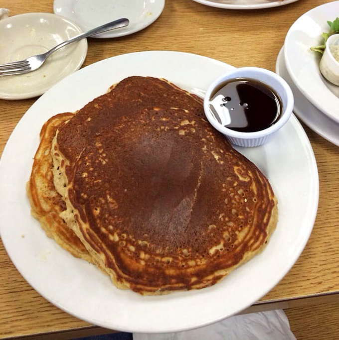 Pancakes so perfectly golden they belong in Fort Knox. One bite of these fluffy beauties and you'll understand why people line up outside on weekends.