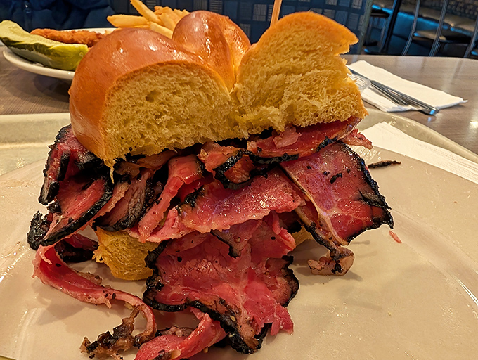 Not so much a sandwich as an architectural marvel of meat. This pastrami masterpiece requires both hands, several napkins, and absolutely zero shame.