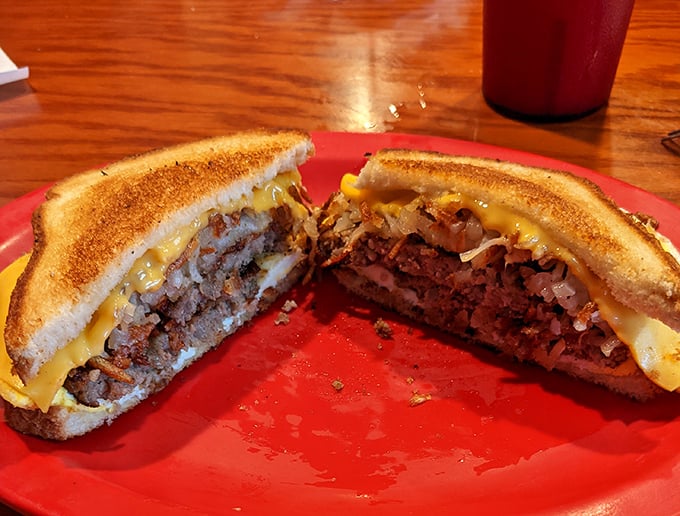 This isn't just a patty melt &ndash; it's a masterclass in sandwich engineering with perfectly grilled bread revealing layers of beefy, cheesy goodness. 