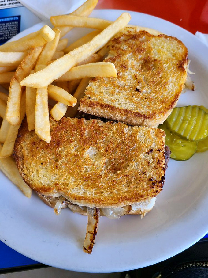 Golden-grilled perfection meets melty cheese in a patty melt that would make your cardiologist nervous and your taste buds ecstatic.