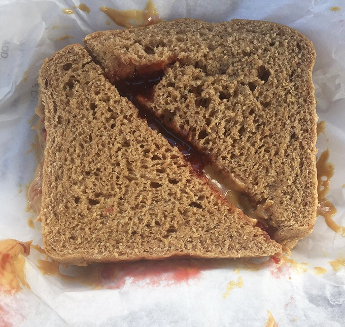 Behold the humble peanut butter sandwich, elevated to art form. That wheat bread barely containing its nutty, jammy goodness is a sight to behold.