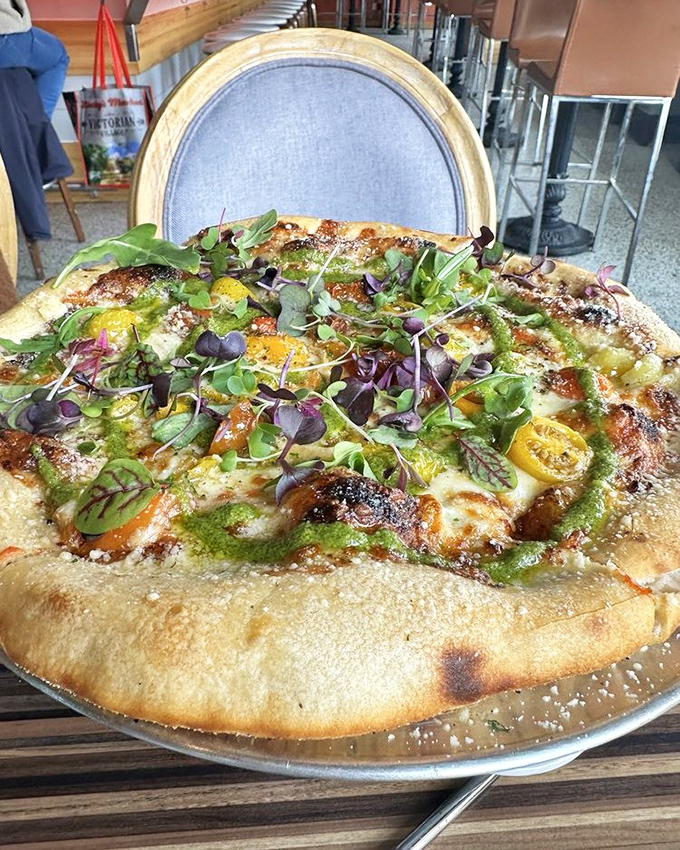 This isn't just pizza; it's a garden party where colorful tomatoes and microgreens dance atop a perfectly charred crust.