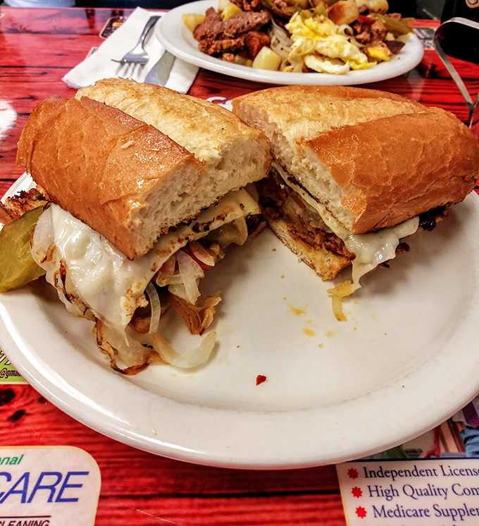 The sandwich that launched a thousand lunch breaks &ndash; a proper Pittsburgh cheesesteak on crusty bread that demands to be eaten, not photographed.