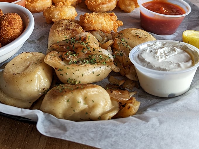 Pillowy pierogies basking in buttery bliss. These potato-filled pockets of joy are what comfort food dreams are made of.
