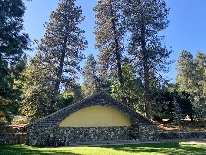 This stone amphitheater nestled among towering pines offers a peaceful retreat from the bustle of downtown exploration.
