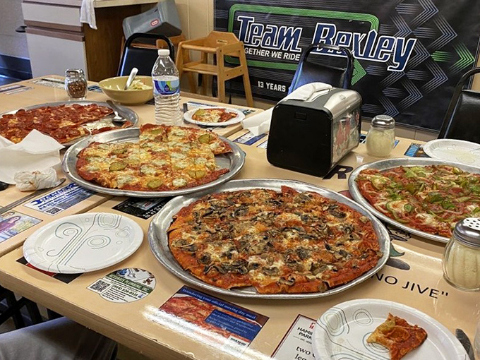 The family table&mdash;where multiple pizzas create a mosaic of possibilities and the phrase "I'll just have one slice" becomes the evening's biggest lie.