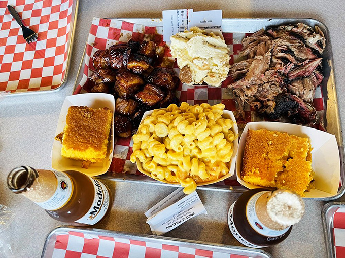 The barbecue platter that makes you want to cancel your afternoon plans. Two cornbreads because one is never enough for this meaty symphony.