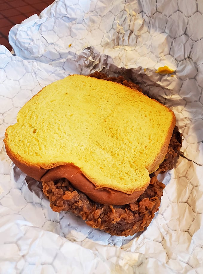 The humble pork chop sandwich: proof that sometimes the simplest combinations—crispy meat and soft bread—create the most profound culinary experiences.